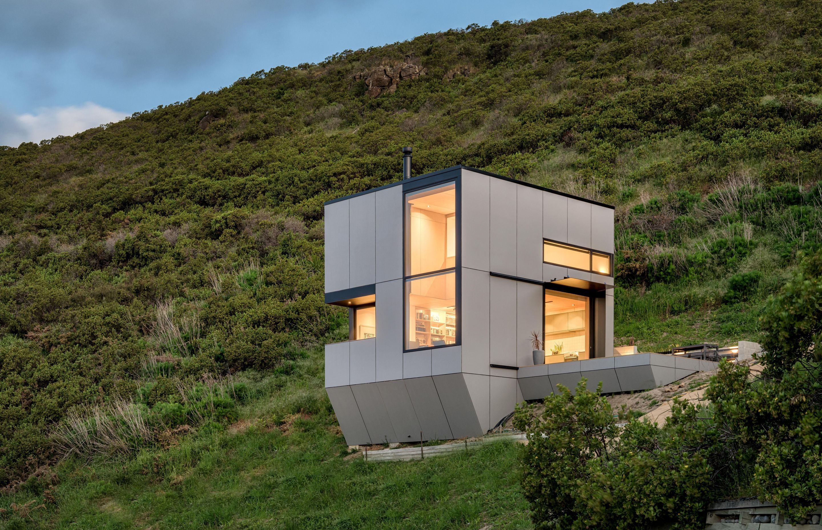 A distinctive bunker-like residence commands attention nestled in the ...