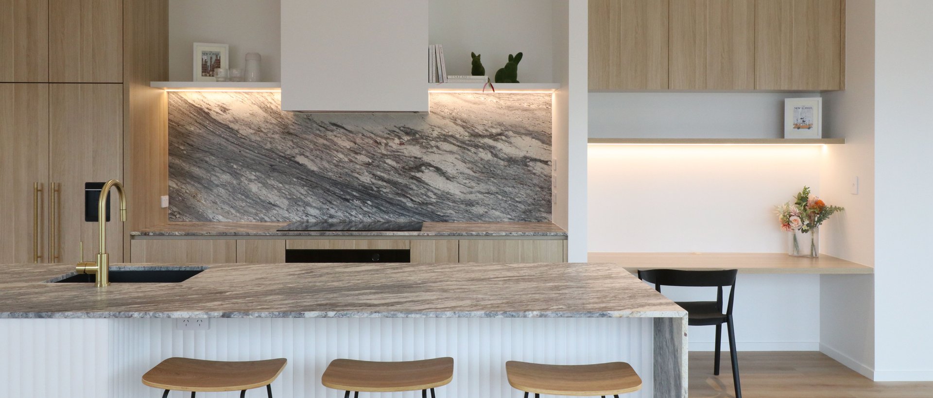 Curved Timber Island with Leathered Granite Elegance by Fluid Interiors ...