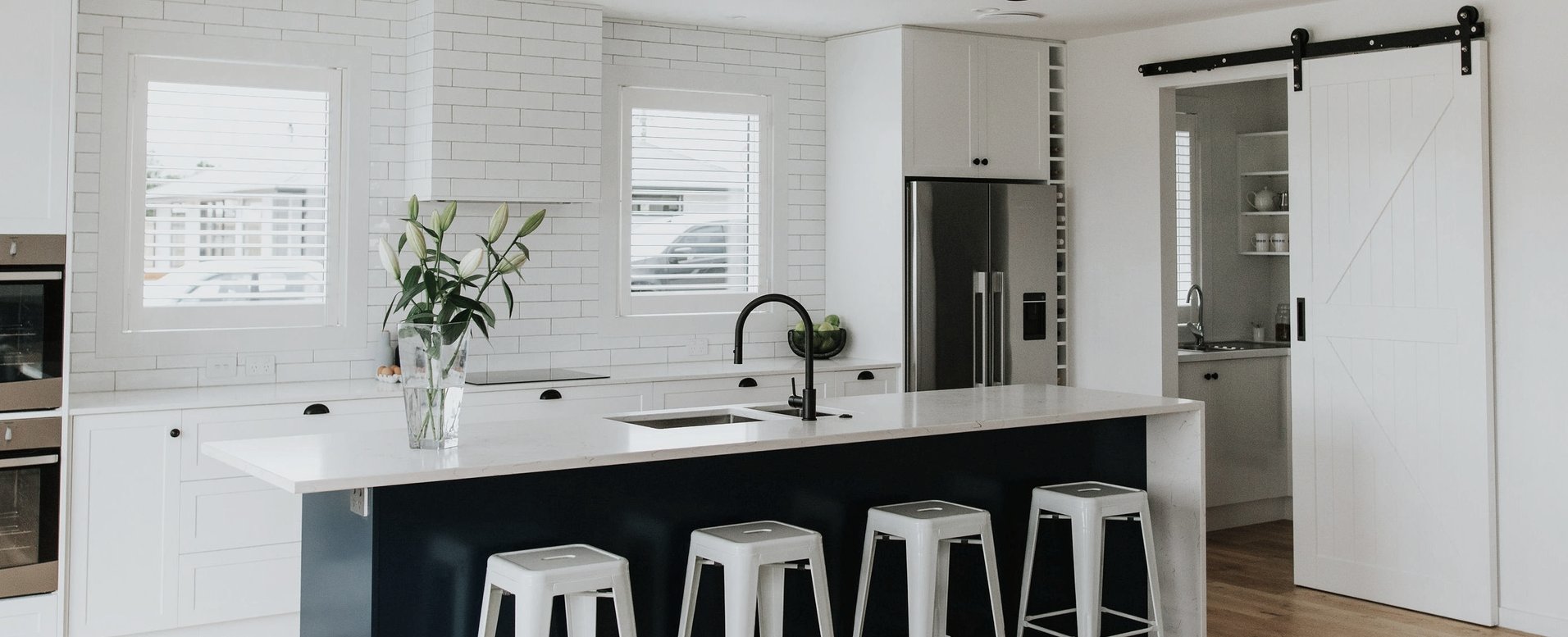 Sleek White Kitchen - NZ Panels Group | ArchiPro NZ