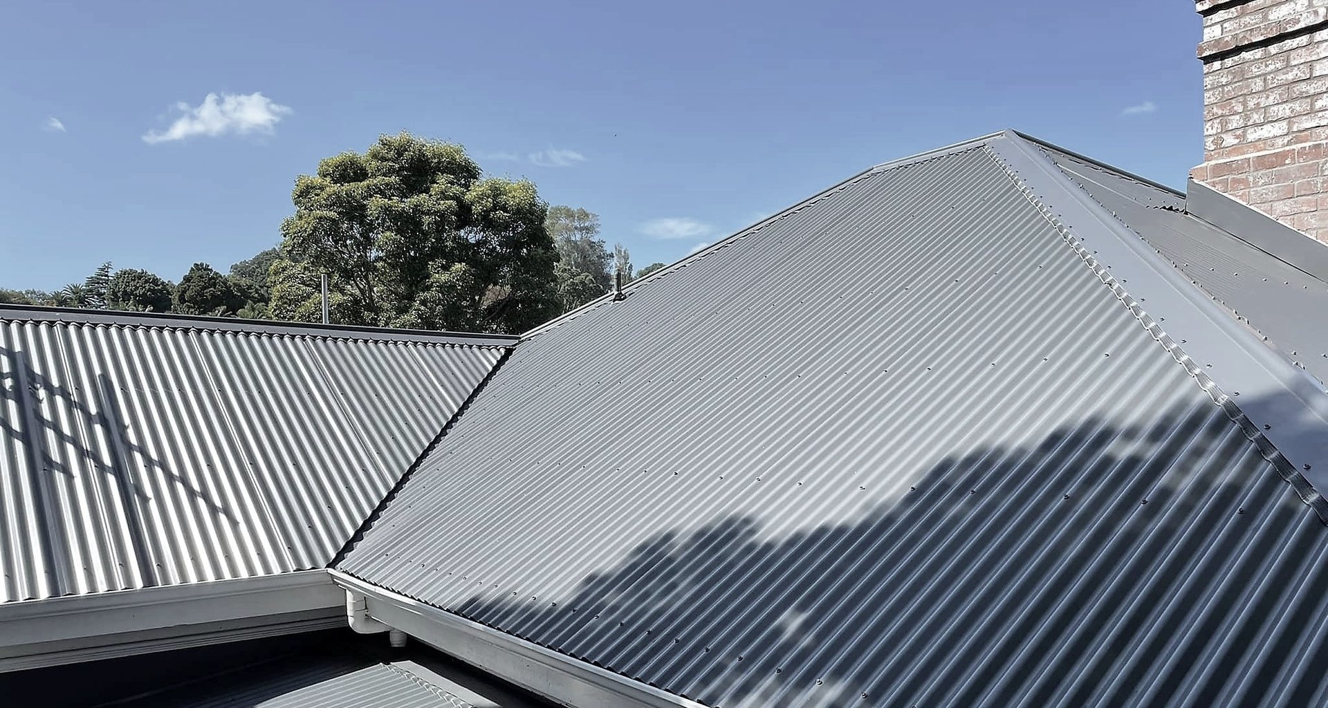 Villa With Sloped Garage by HDK Long Run Roofing | ArchiPro NZ